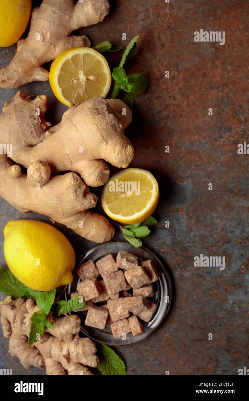 Ingredients for ginger tea. Ginger, lemon, mint and brown sugar on ...