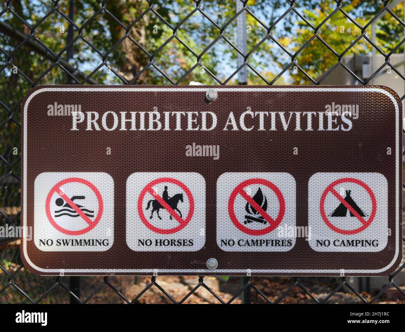 Closeup shot of prohibited activities sign attached to a fence Stock ...