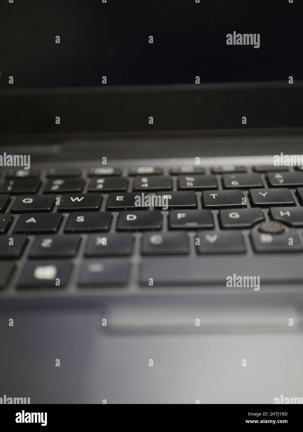 Selective focus shot of a black laptop keyboard in vertical Stock Photo ...