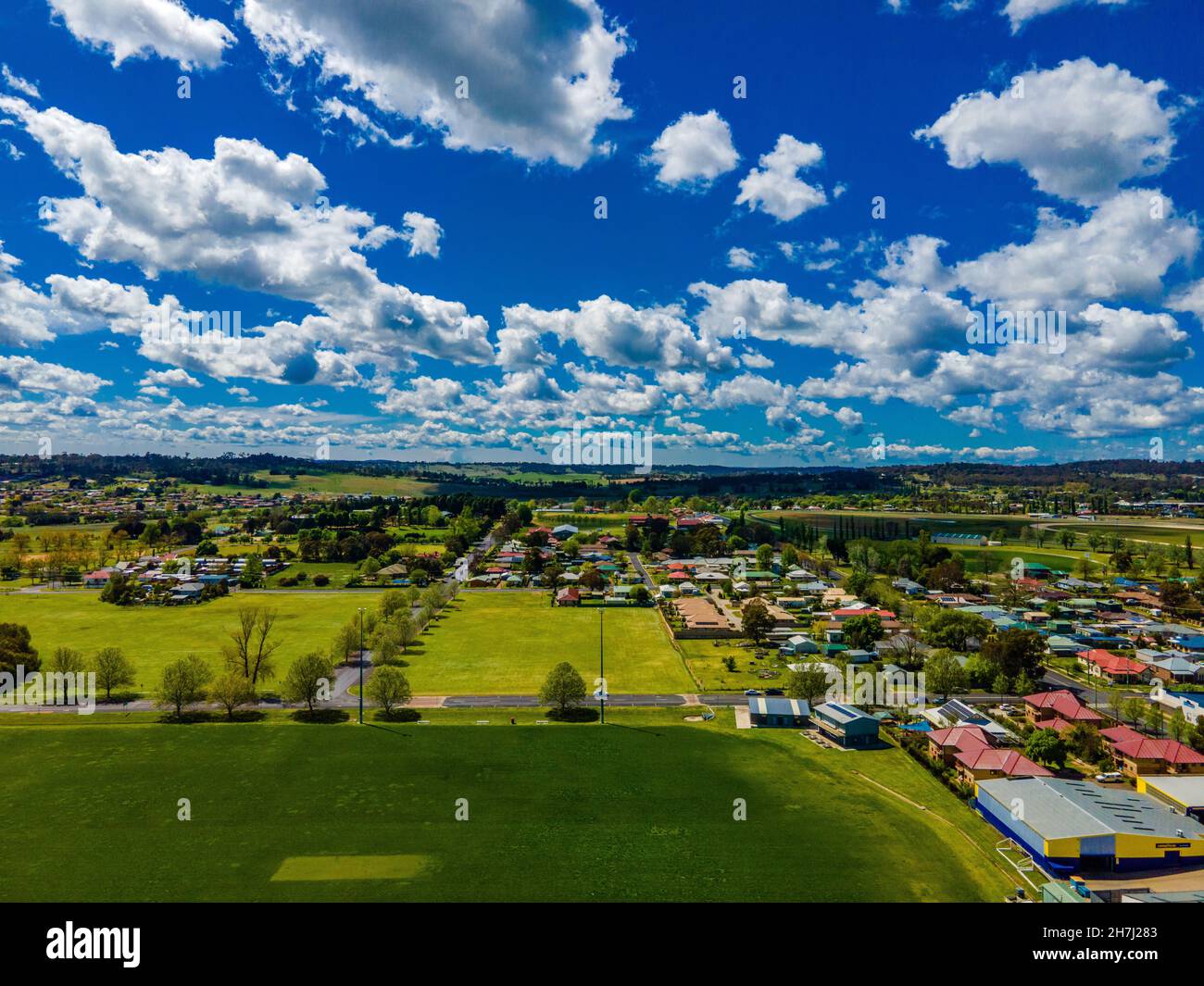 Aerial view of the town of Armidale with colorful buildings and green ...