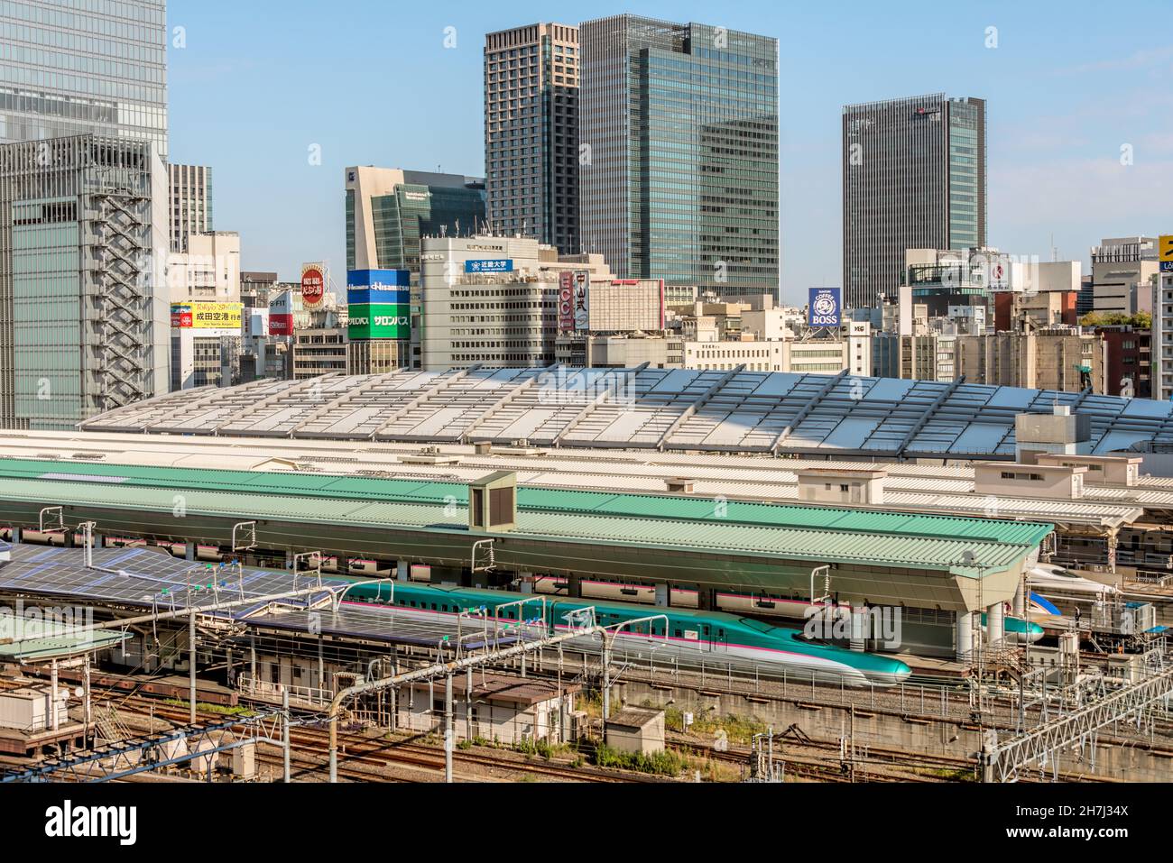 View of Tokyo Central Station with Shinkansen trains and the skyline of ...