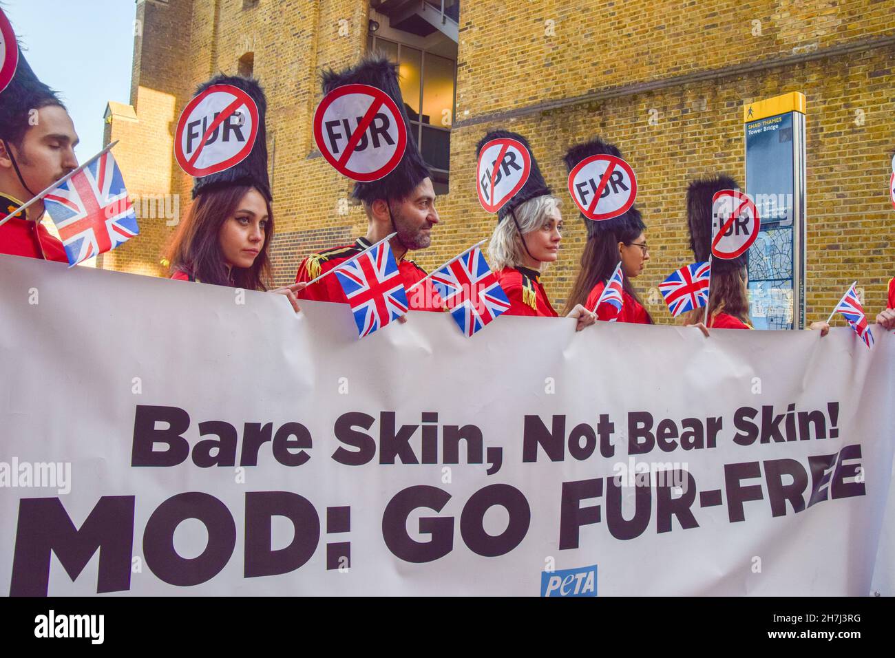 Activists wearing guard costumes and caps with anti-fur signs hold ...