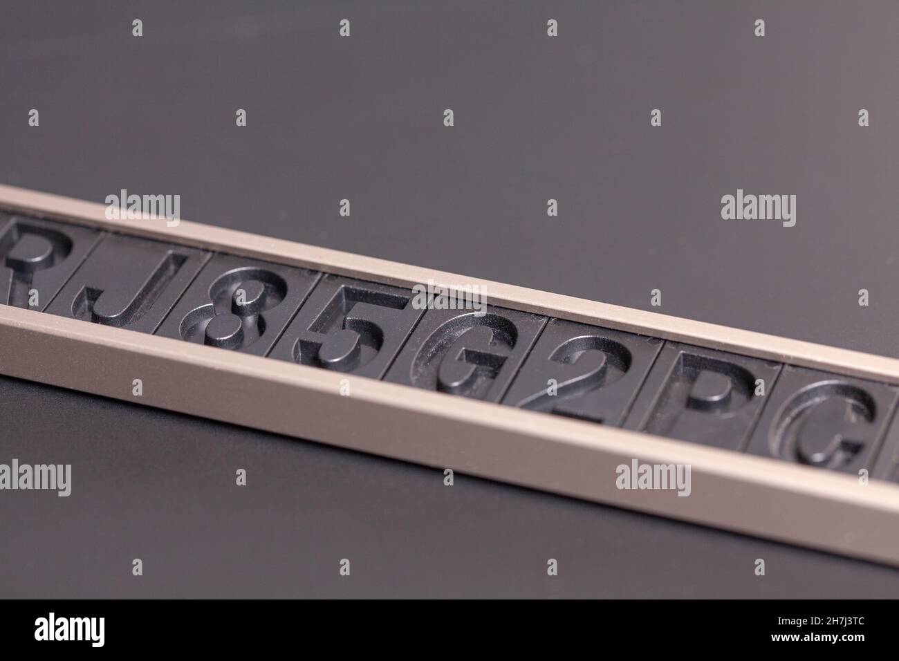 letterpress alphabet and numbers on black background in frame Stock ...