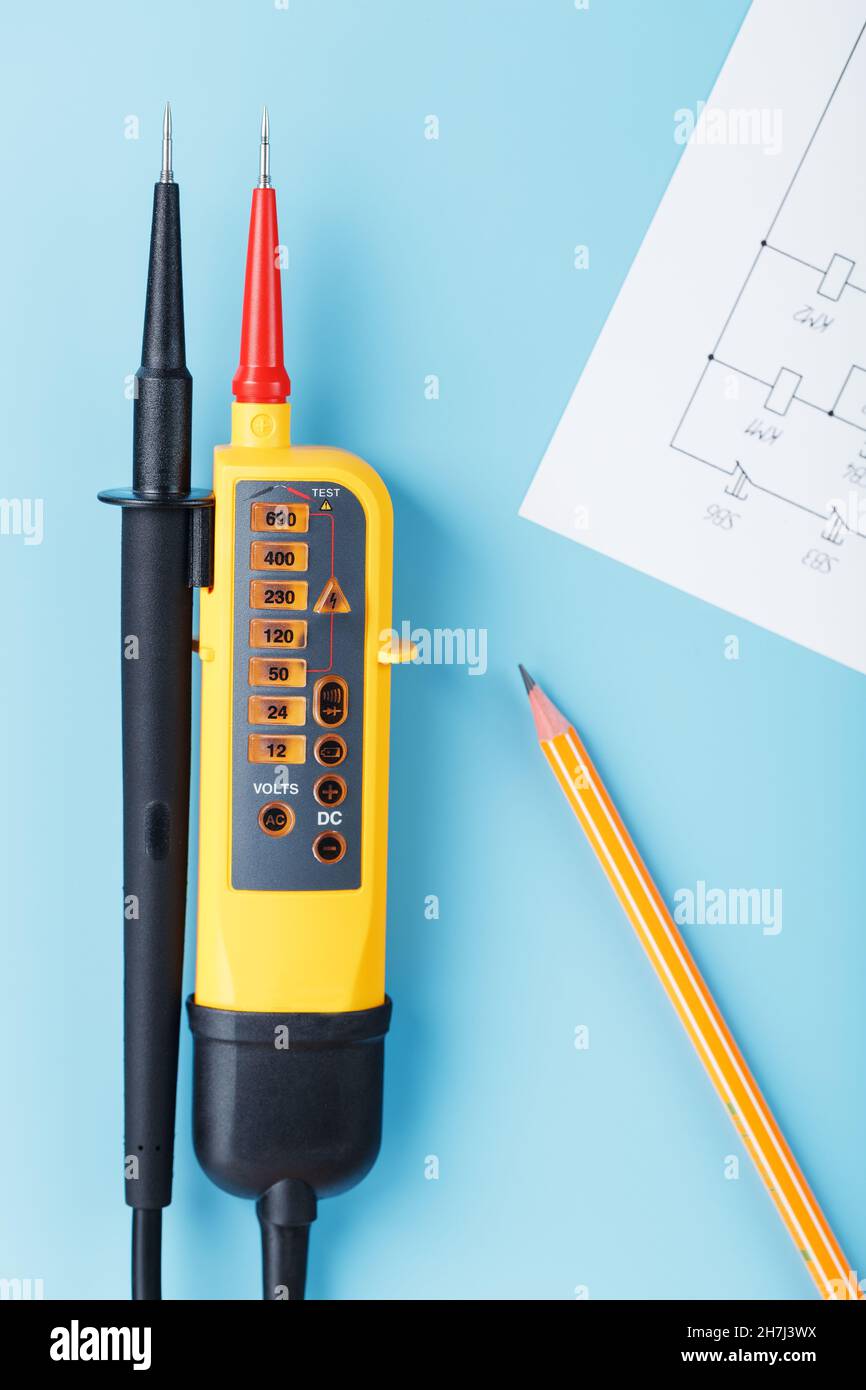 Yellow voltage indicator with an electrical diagram on a blue ...