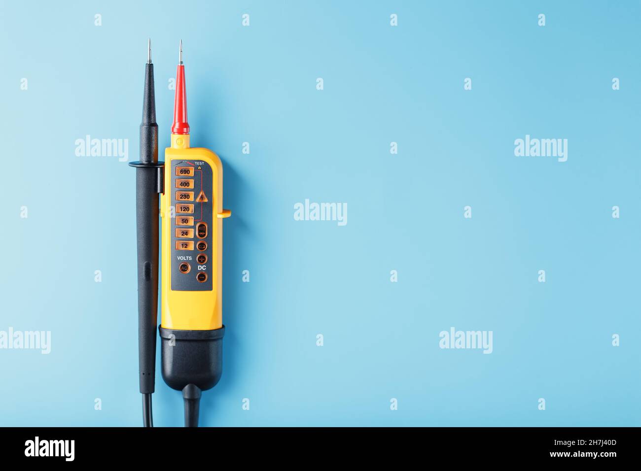 Two-pole voltage indicator close-up on a blue background. Testing and ...