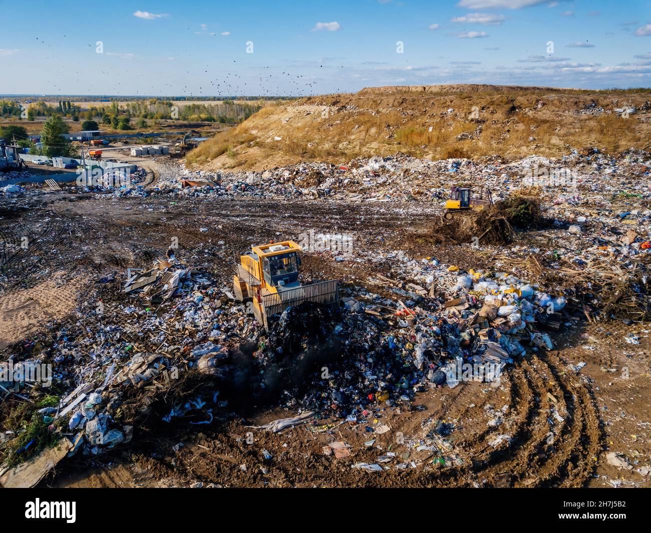 Garbage dump and working dump truck and bulldozer, aerial view Stock ...