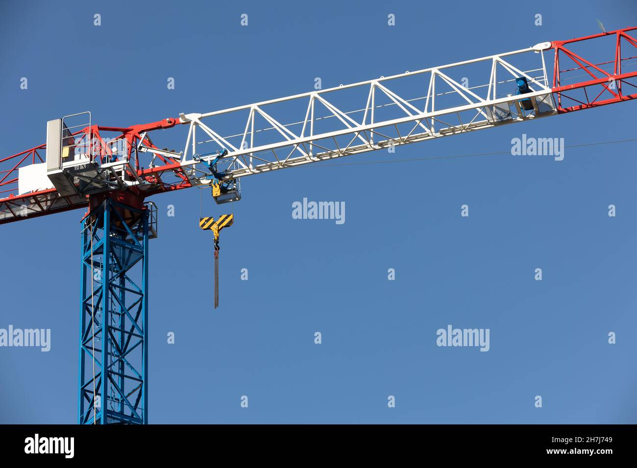 blue, white and red construction crane against the sky Stock Photo - Alamy