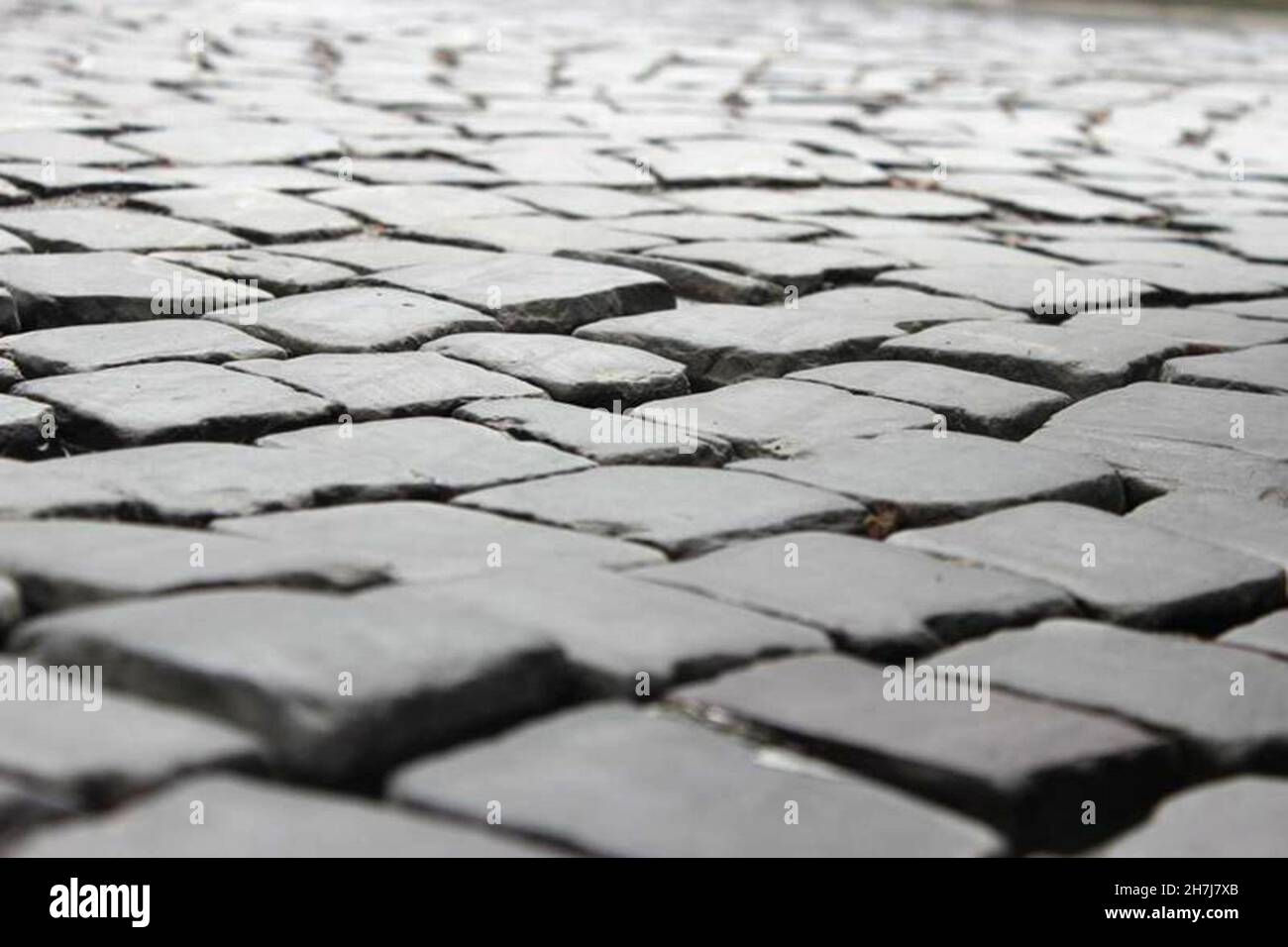 Grey stone block pavement. Old brick road background, close view Stock ...