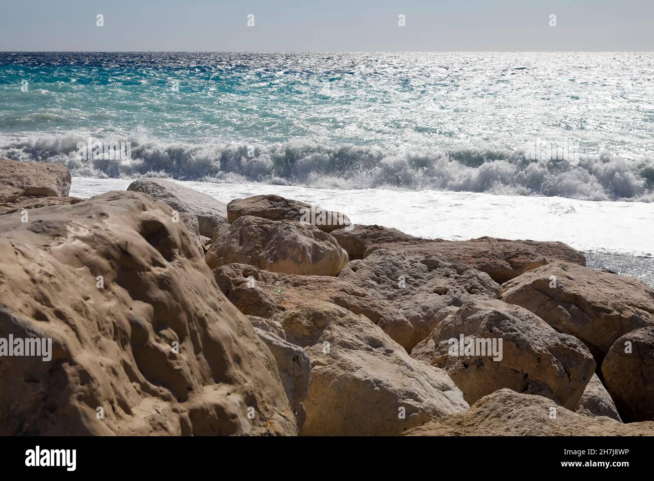 Huge stones on the beach at the Mediterranean Sea protect seashore from ...