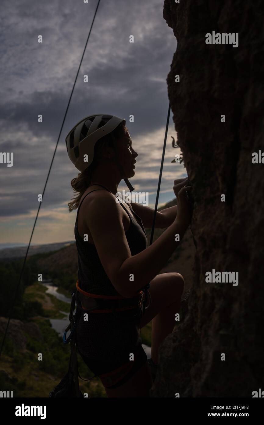 Silhouette portrait of beautiful girl climbing the high hill Stock ...