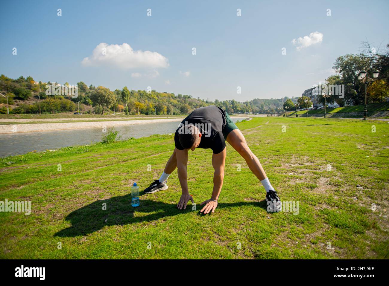 Attractive adn handsome guy is stretching himself before trainnig Stock ...