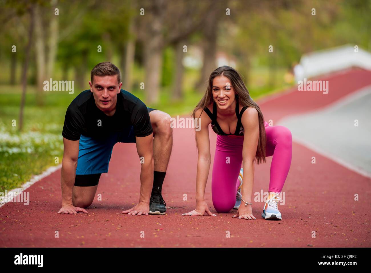 Portrait of a young man working out with his girlfriend and ready to ...