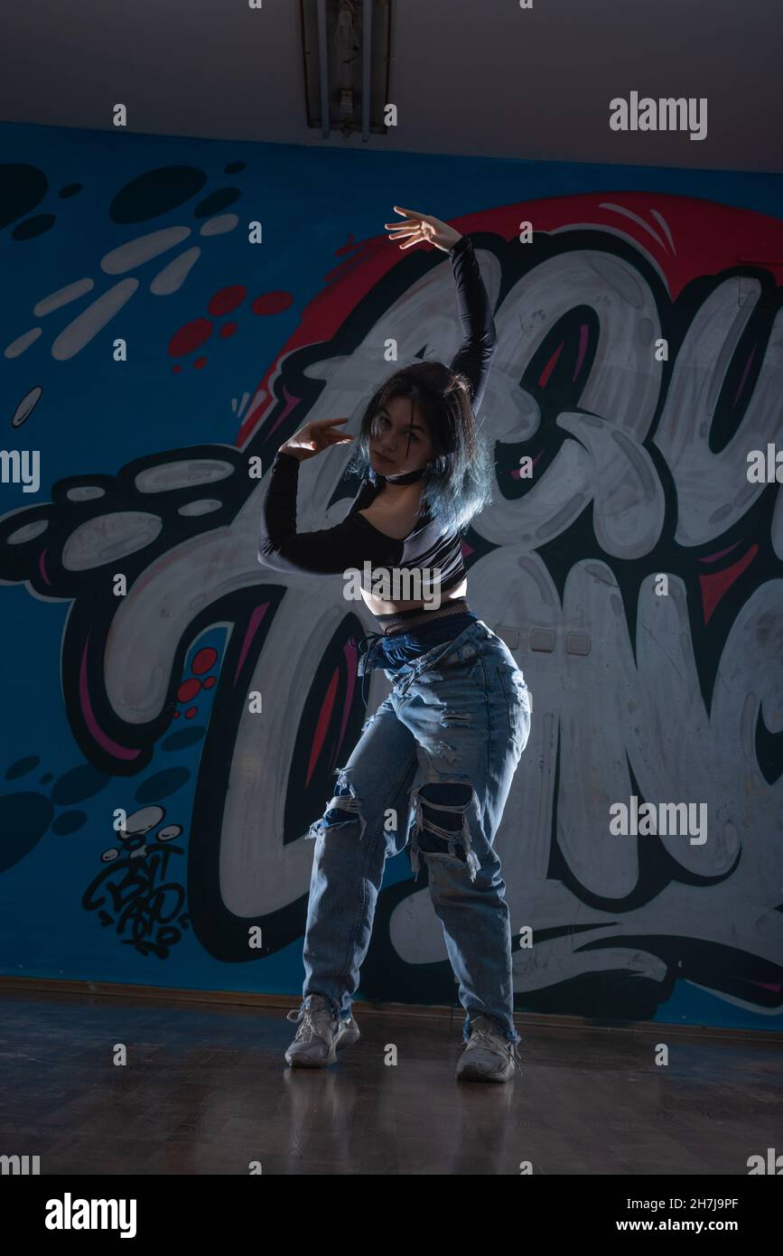 Female Dancer In Activewear Squatting On The Floor Of Modern Dance