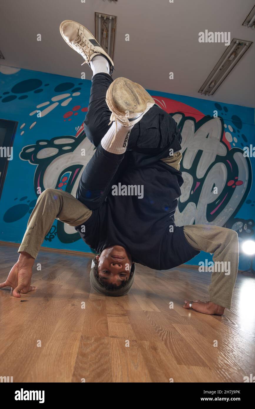 Modern rapper dancing in garage. Urban lifestyle, hip hop Stock Photo ...