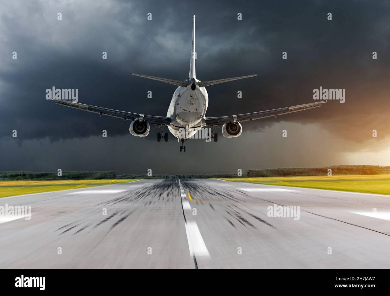 Airplane approach at the airport landing in bad weather storm hurricane ...