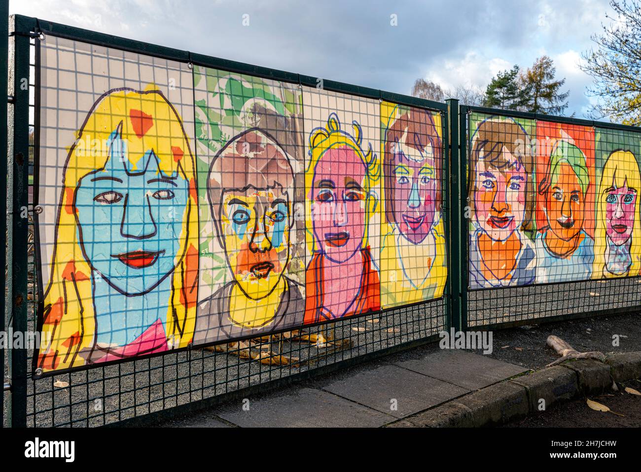 Colorful Portraits Hang On The Fence Of A School In Berlin Stock Photo ...