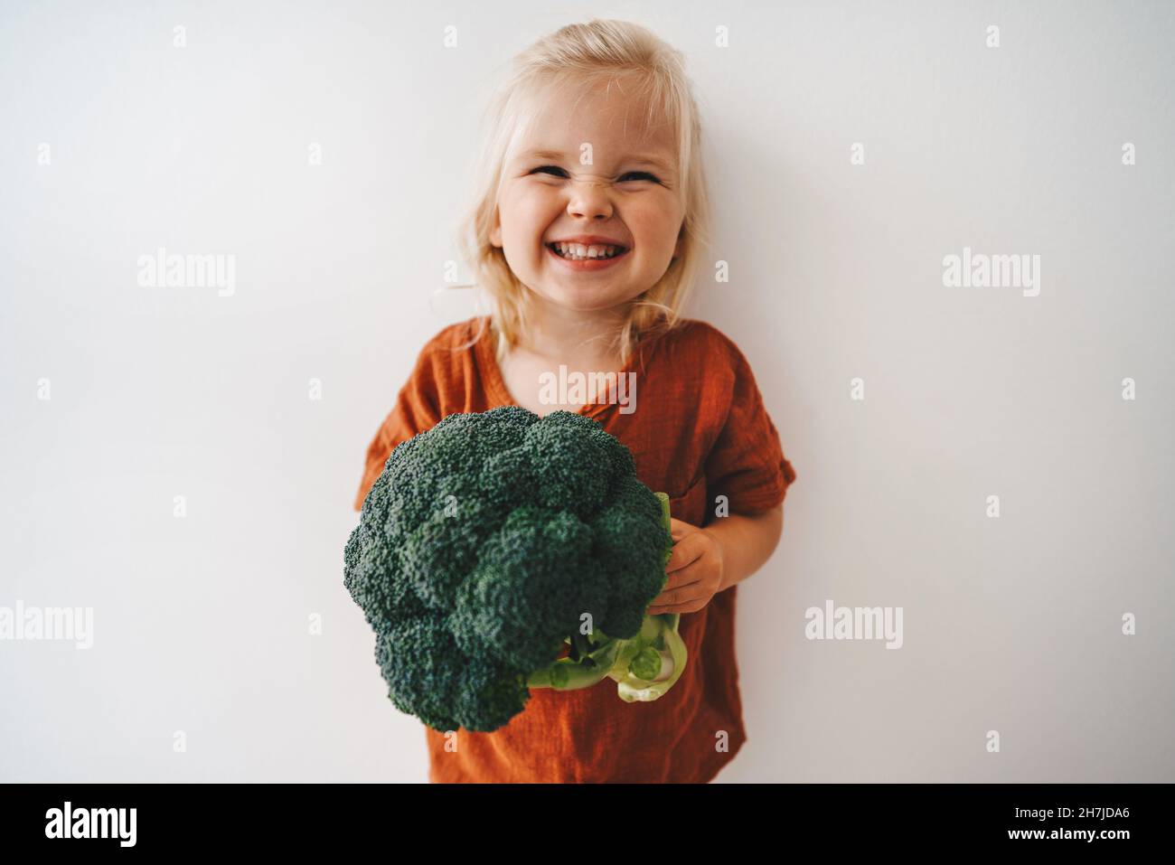 Child with broccoli vegetable healthy food vegan cooking eating ...