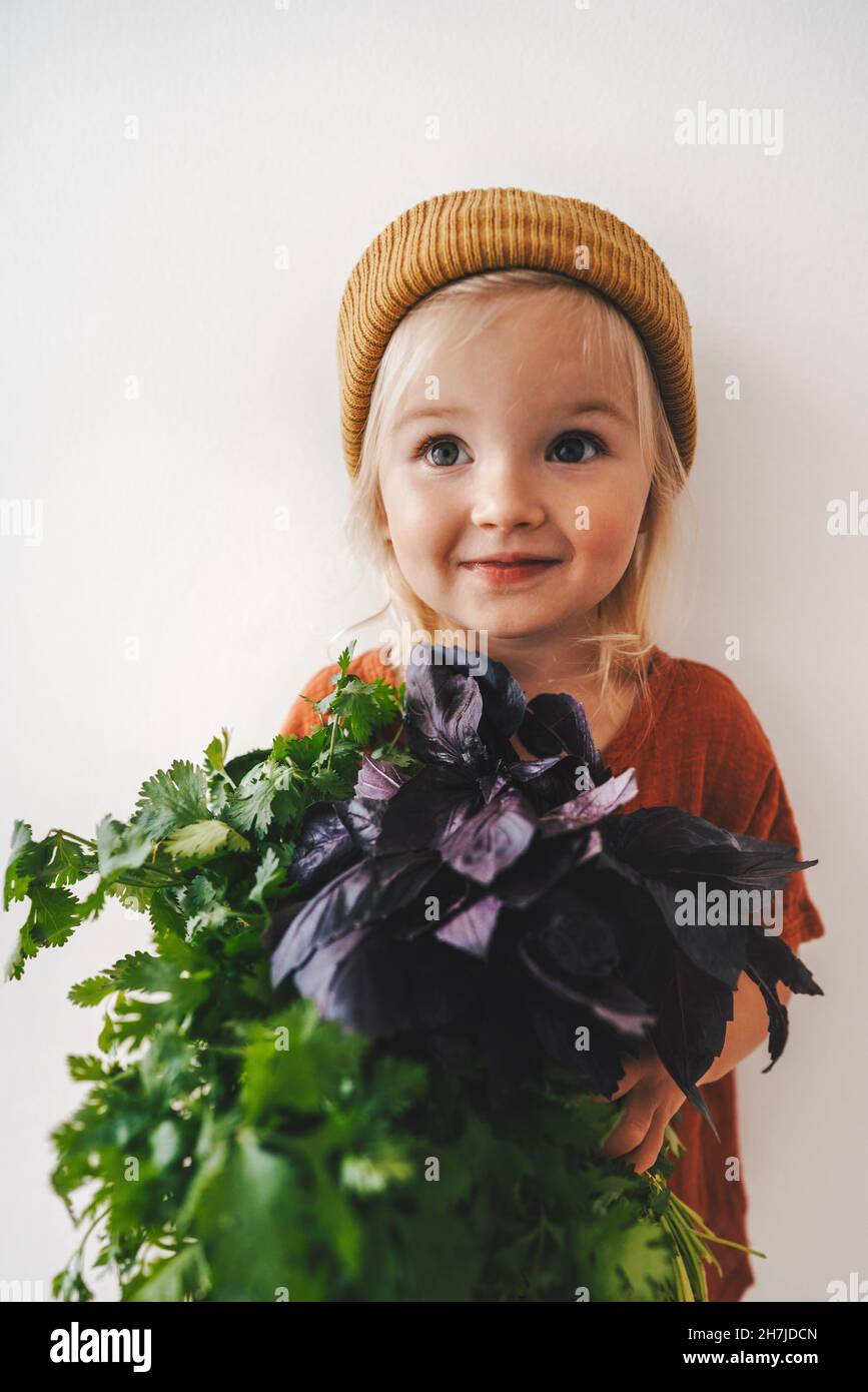 Child with coriander and basil bunch vegan food healthy eating organic ...