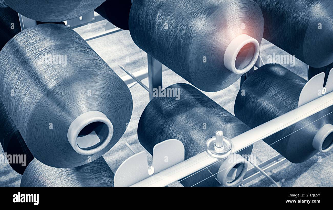Reels of textile yarn blue thread at industrial weaving manufacturing ...