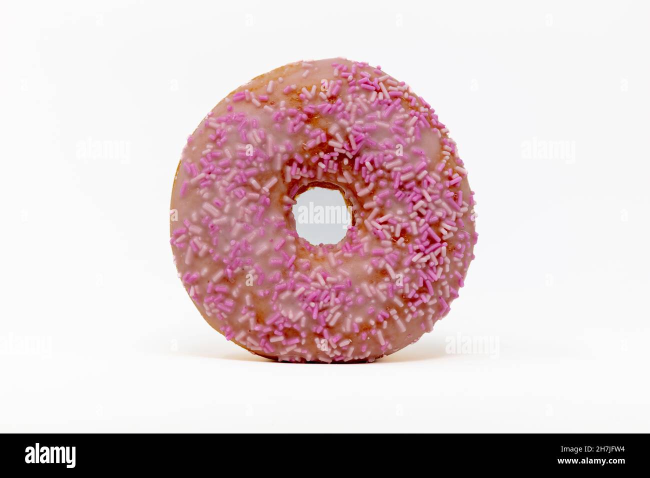 M&S Pink doughnut with sprinkles on a white background Stock Photo - Alamy