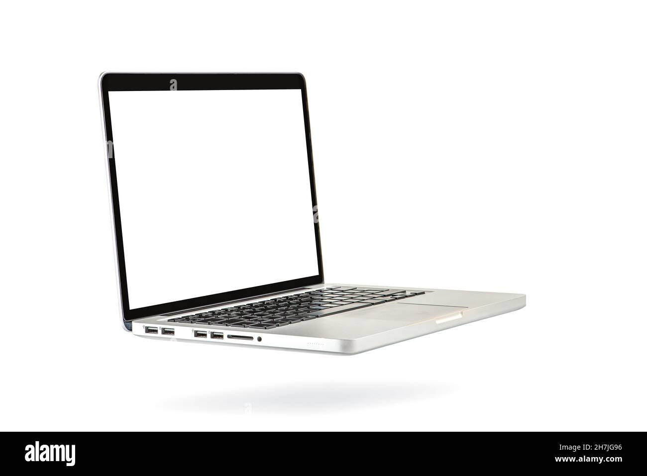 A laptop hovers in the air casting a shadow on a white isolated ...