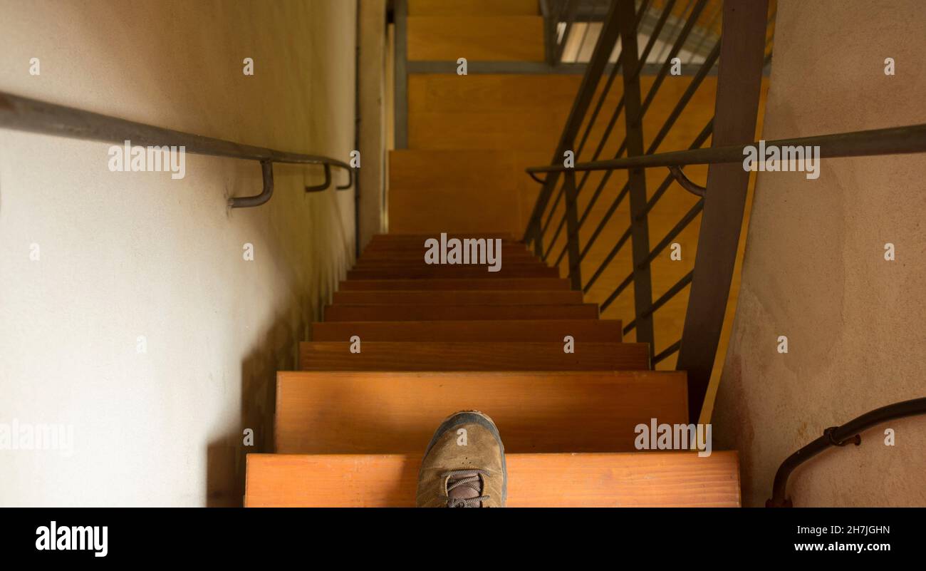 Very steep and narrow stairs. Man stand over first step Stock Photo - Alamy