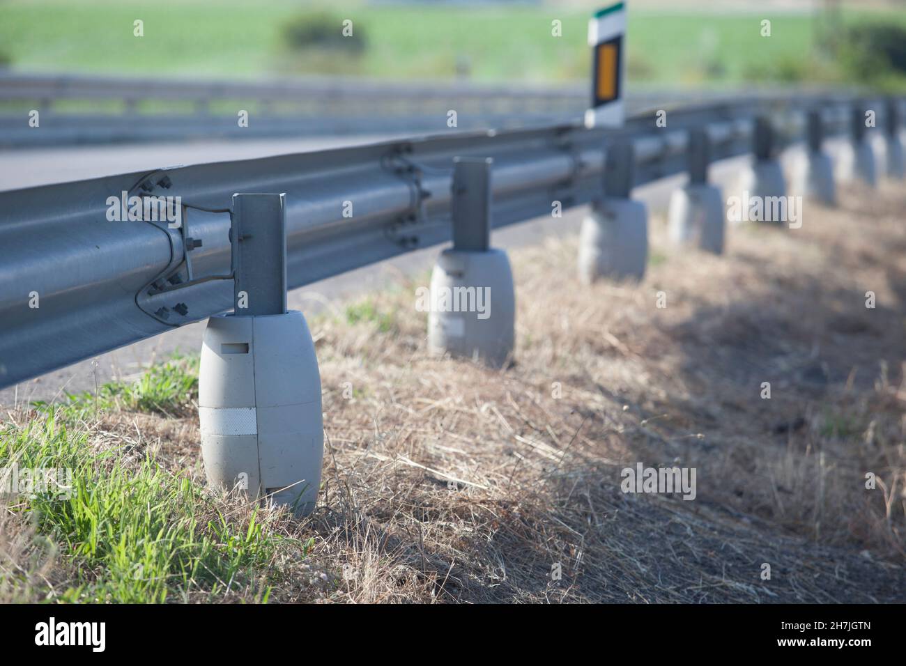 Guardrails poles covered with crash-absorber cylinder. Motorbikers ...