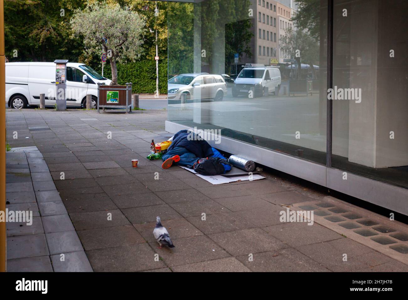 sleeping homeless man on the city street Stock Photo - Alamy