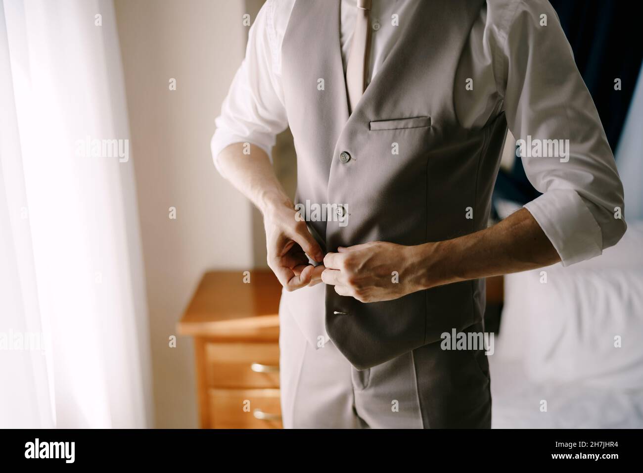 Man buttoning up dress shirt hi-res stock photography and images - Alamy
