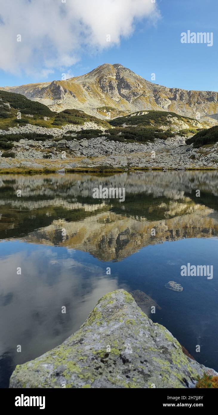 Lake with reflection in it with the hill and the blue sky in the ...