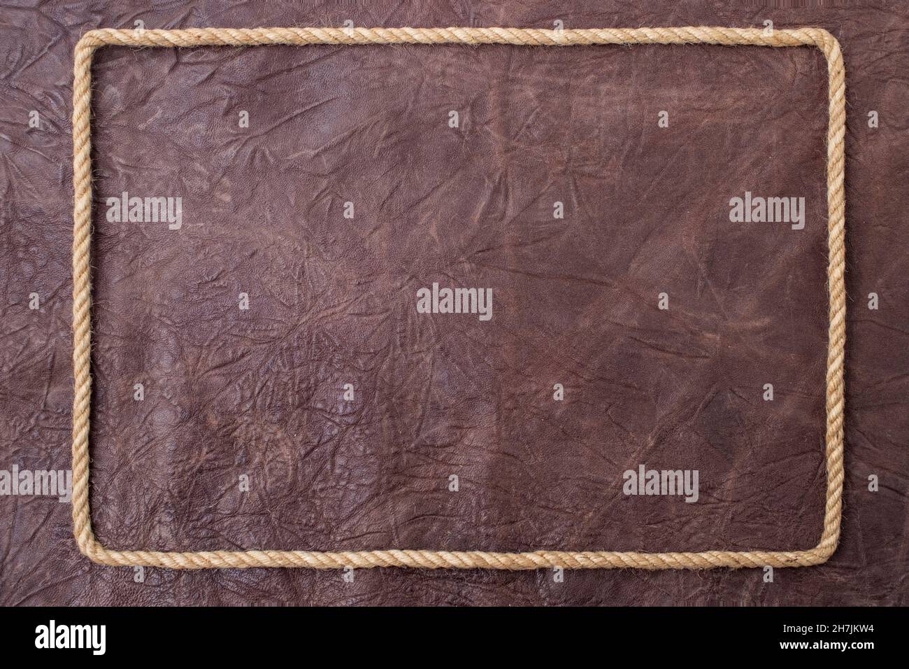 jute rope rectangle on brown wrinkled genuine leather Stock Photo - Alamy