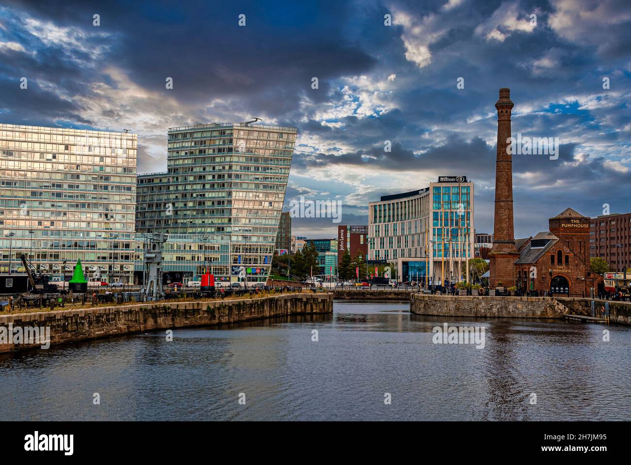 Liverpool waterfront with modern city buildings against cloudy sky ...