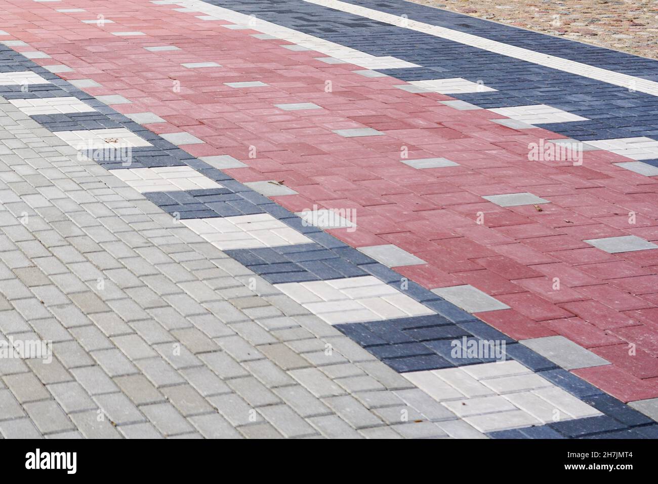 new modern colorful paved walkway and bicycle lane with cobblestones of ...