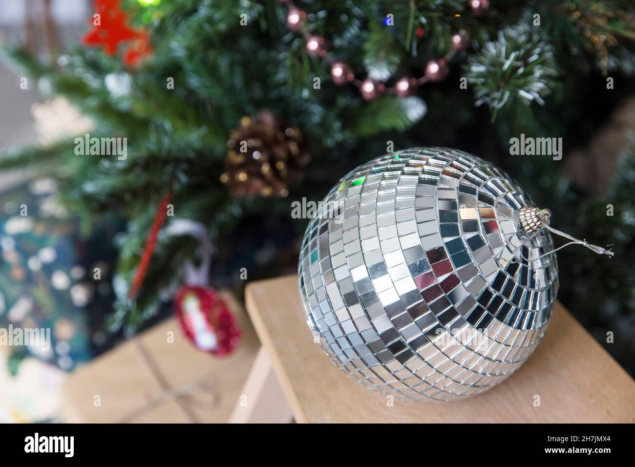 Disco ball on a stool near a Christmas tree as an interior decoration ...