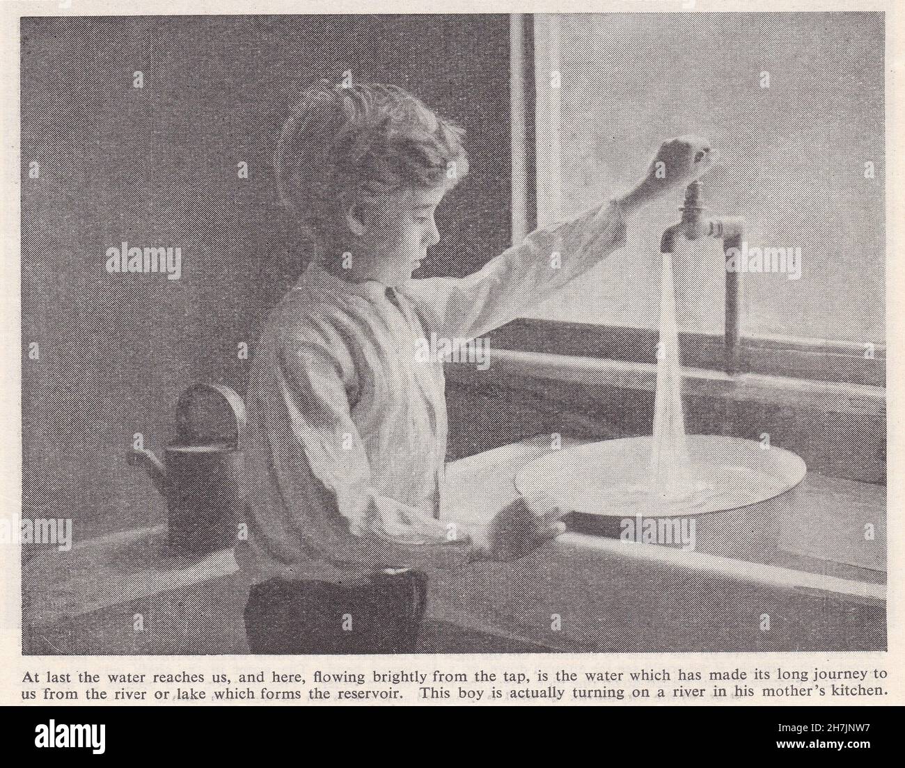Vintage photo of a boy turning on a tap for clean drinking water 1930s ...