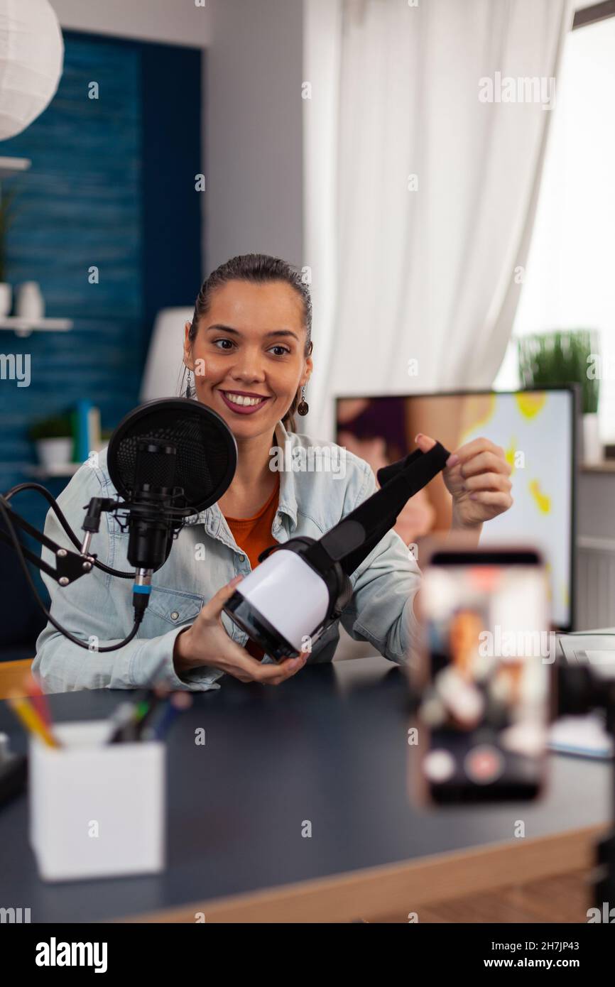 Content creator recording review of VR glasses with smartphone. Online ...