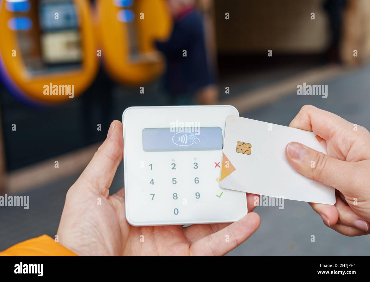 From above of crop anonymous customer making payment with credit card ...