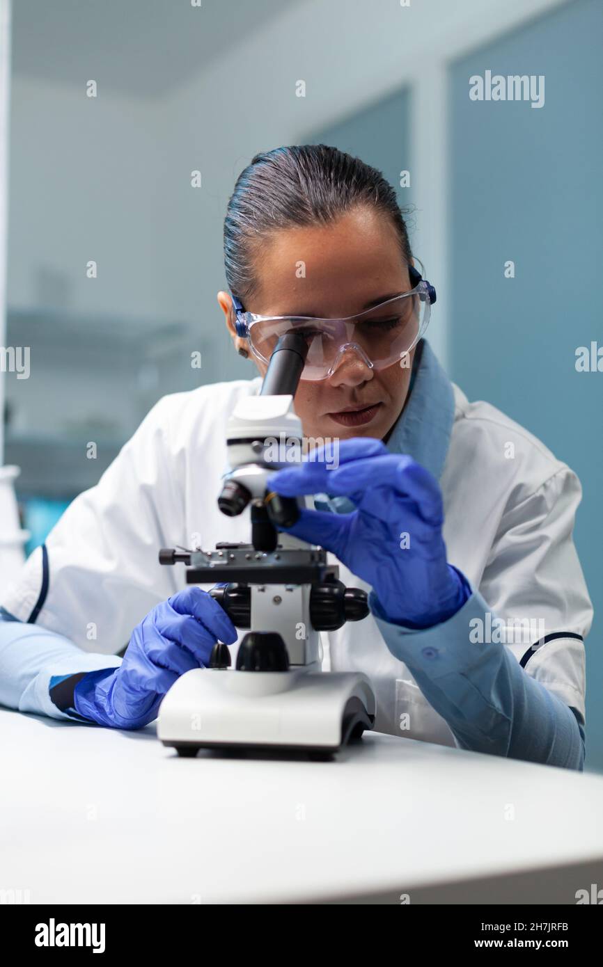 Biologist woman working at vaccine development analyzing blood sample ...