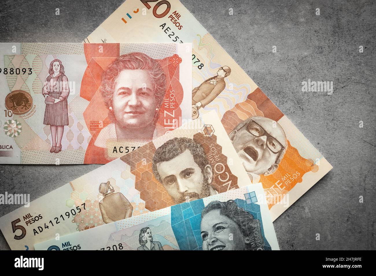 Colombian money, various banknotes filling the frame, Grey background ...