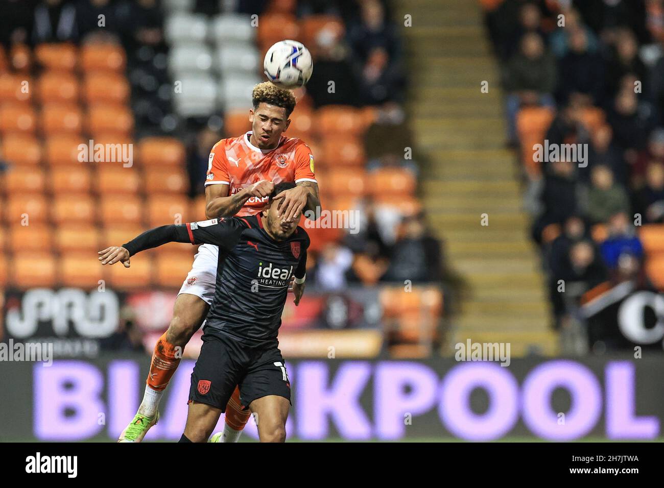 Jordan Gabriel #4 of Blackpool wins the high-ball from Karlan Grant #18 ...