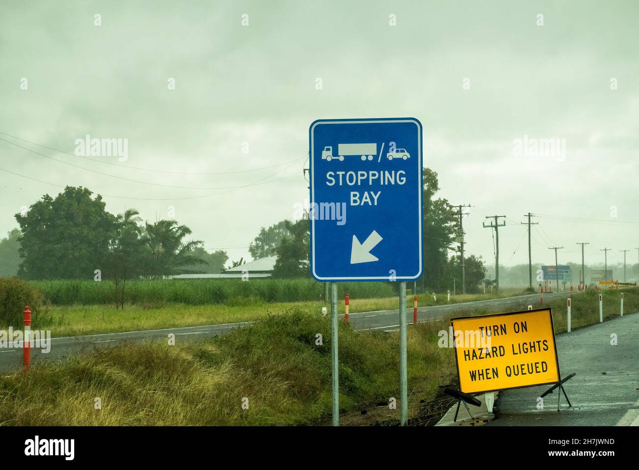 Trucks and cars stopping bay with arrow signage and warning to turn on ...
