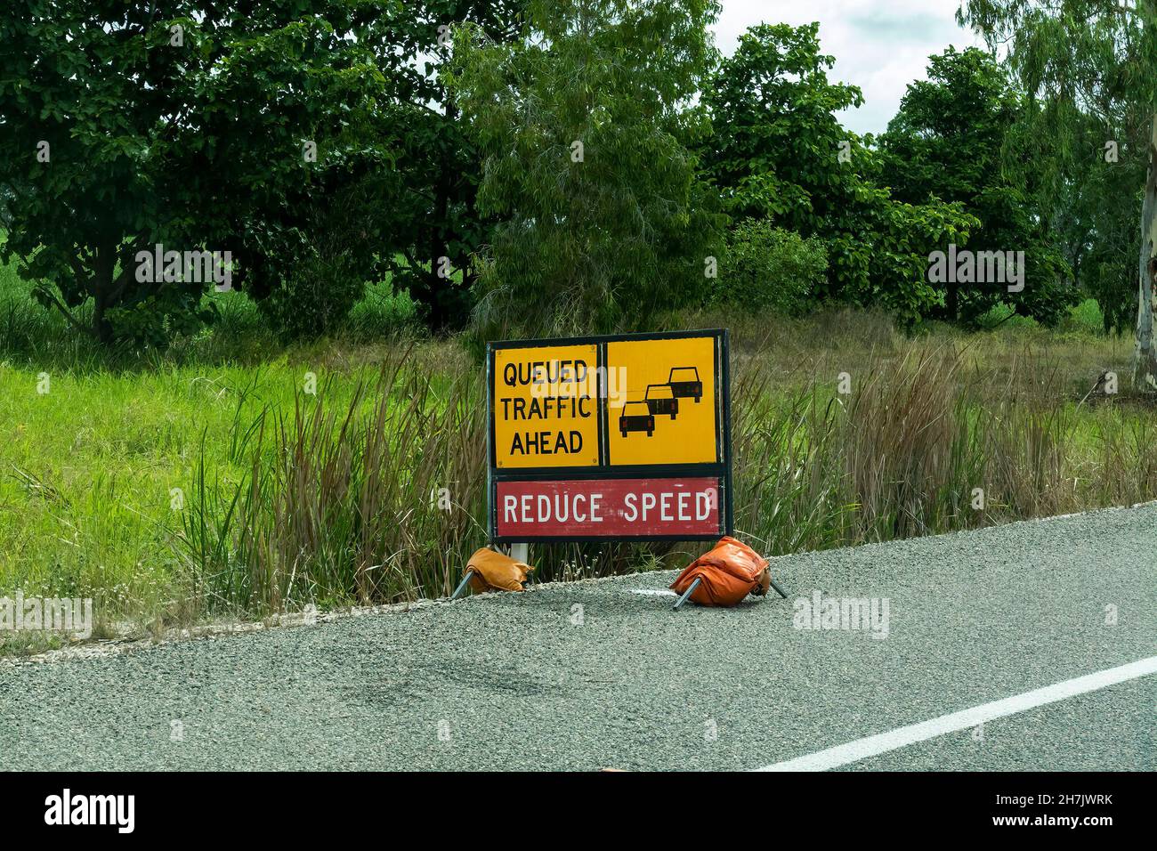 Queued traffic ahead reduce speed signage on country highway Stock ...