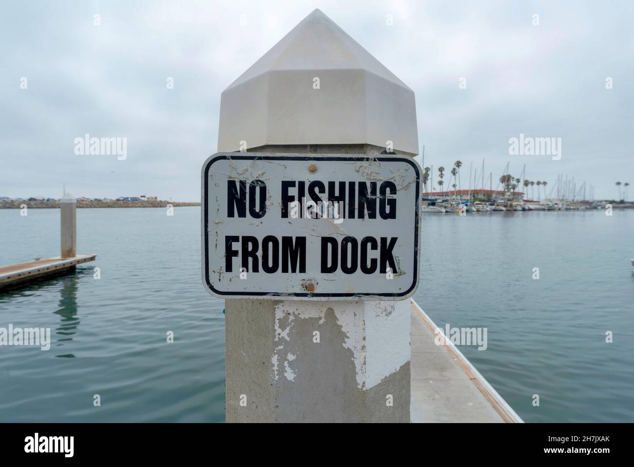 No fishing from dock old signage at Oceanside, California. Close up of ...