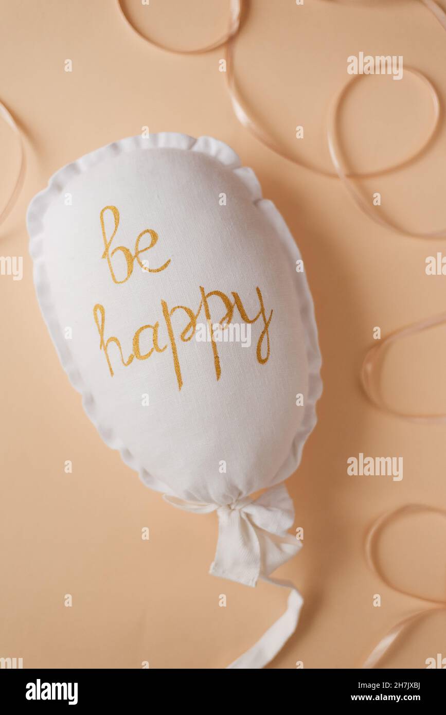 cute inflatable balloon with the words be happy Stock Photo - Alamy