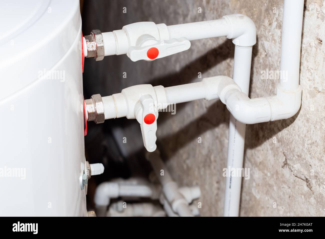 Hot water heating in a country house. A boiler with two pipes through ...