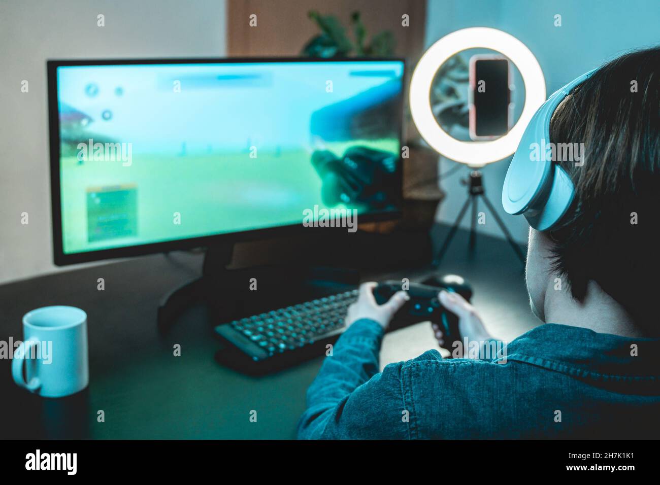 Gamer playing and streaming strategy video game online on twitch ...