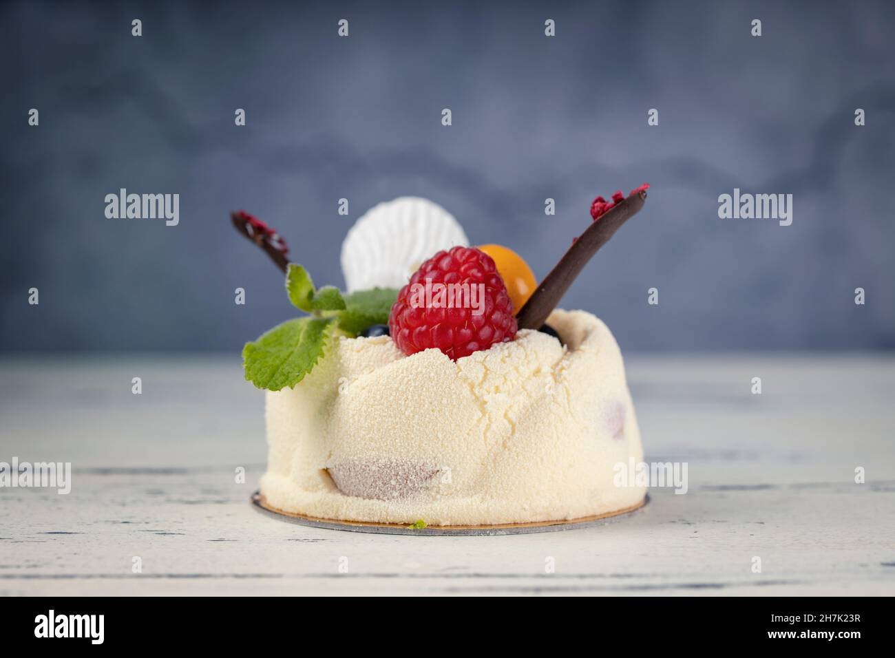 French mousse cake covered with chocolate glaze on wooden background ...