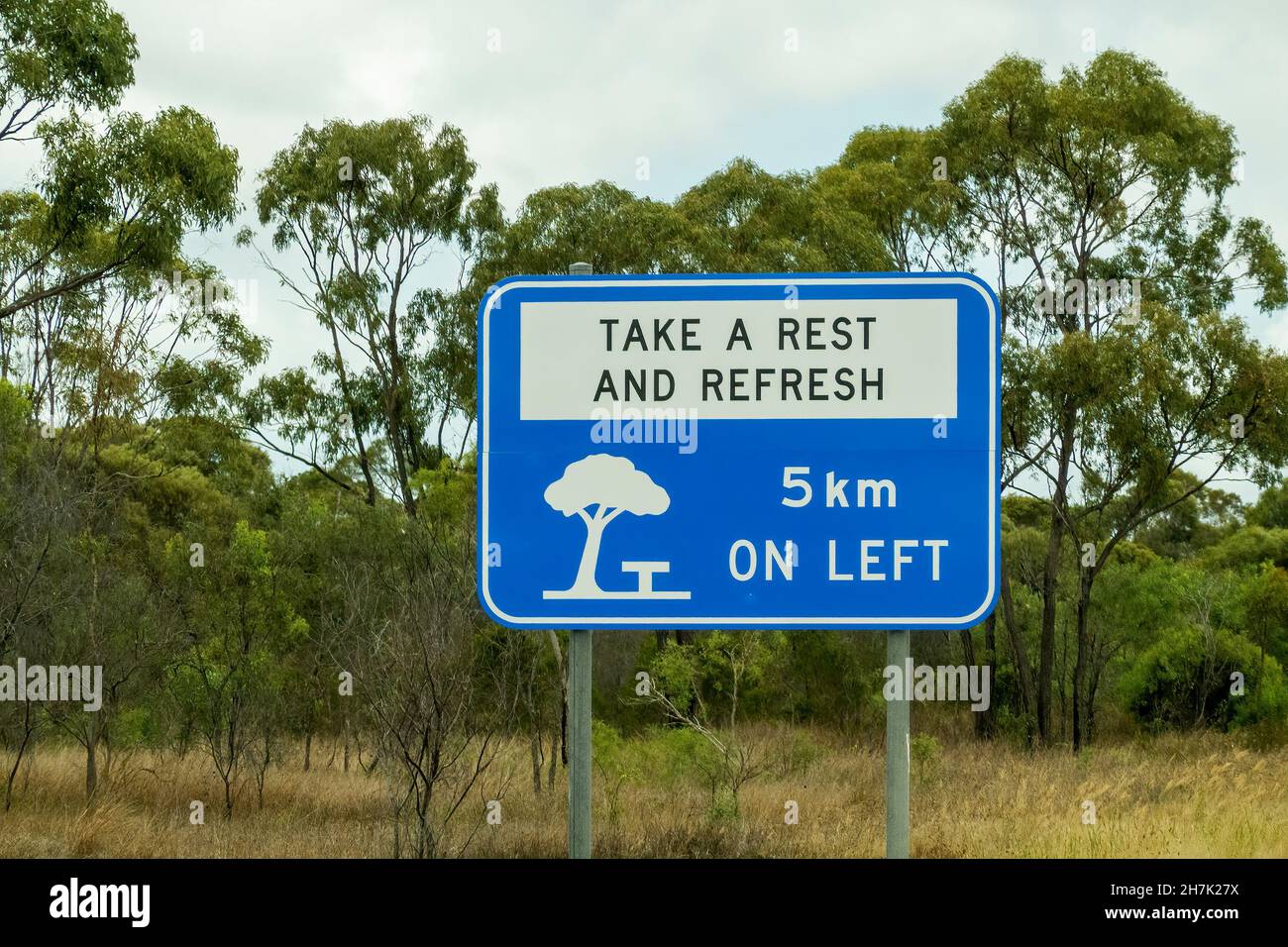 Take a rest and refresh roadside sign for rest area 5 kilometers ahead ...