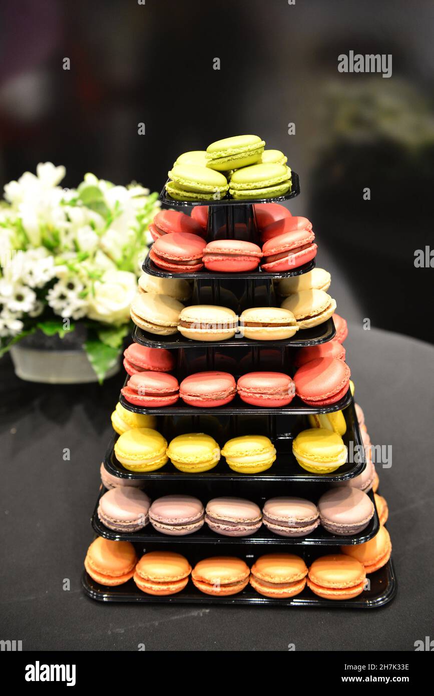 Vertical shot of sweet colorful French macaroons served for the event ...