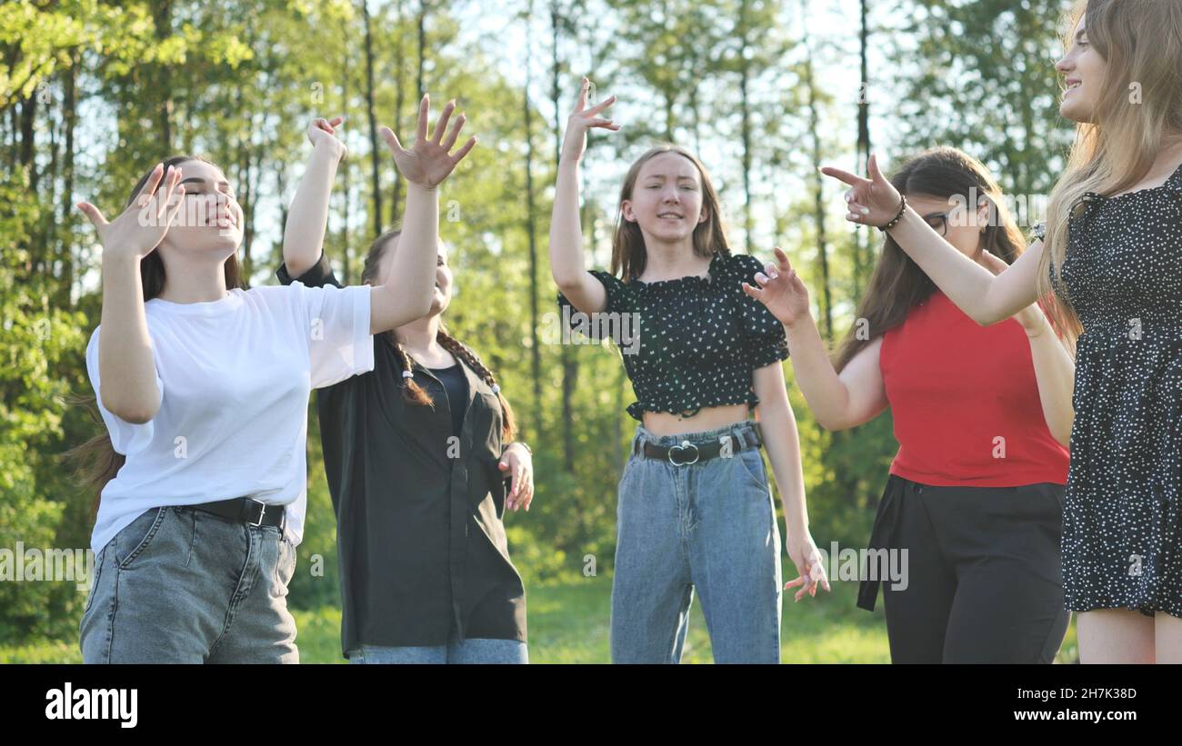 Joyful girls are dancing on a picnic near the forest Stock Photo - Alamy